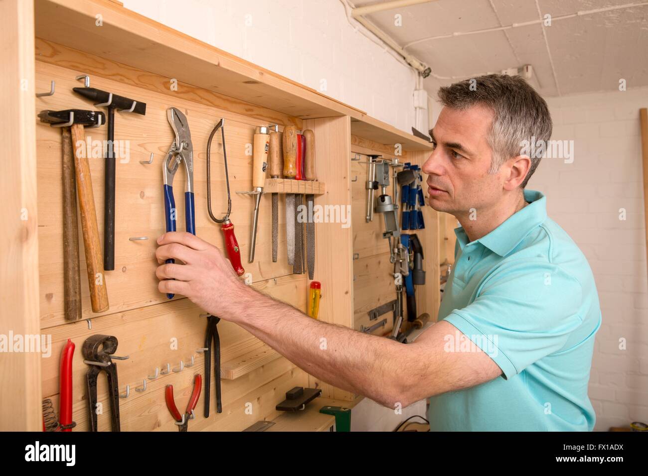 Do-it-yourselfer searches suitable tools Stock Photo - Alamy