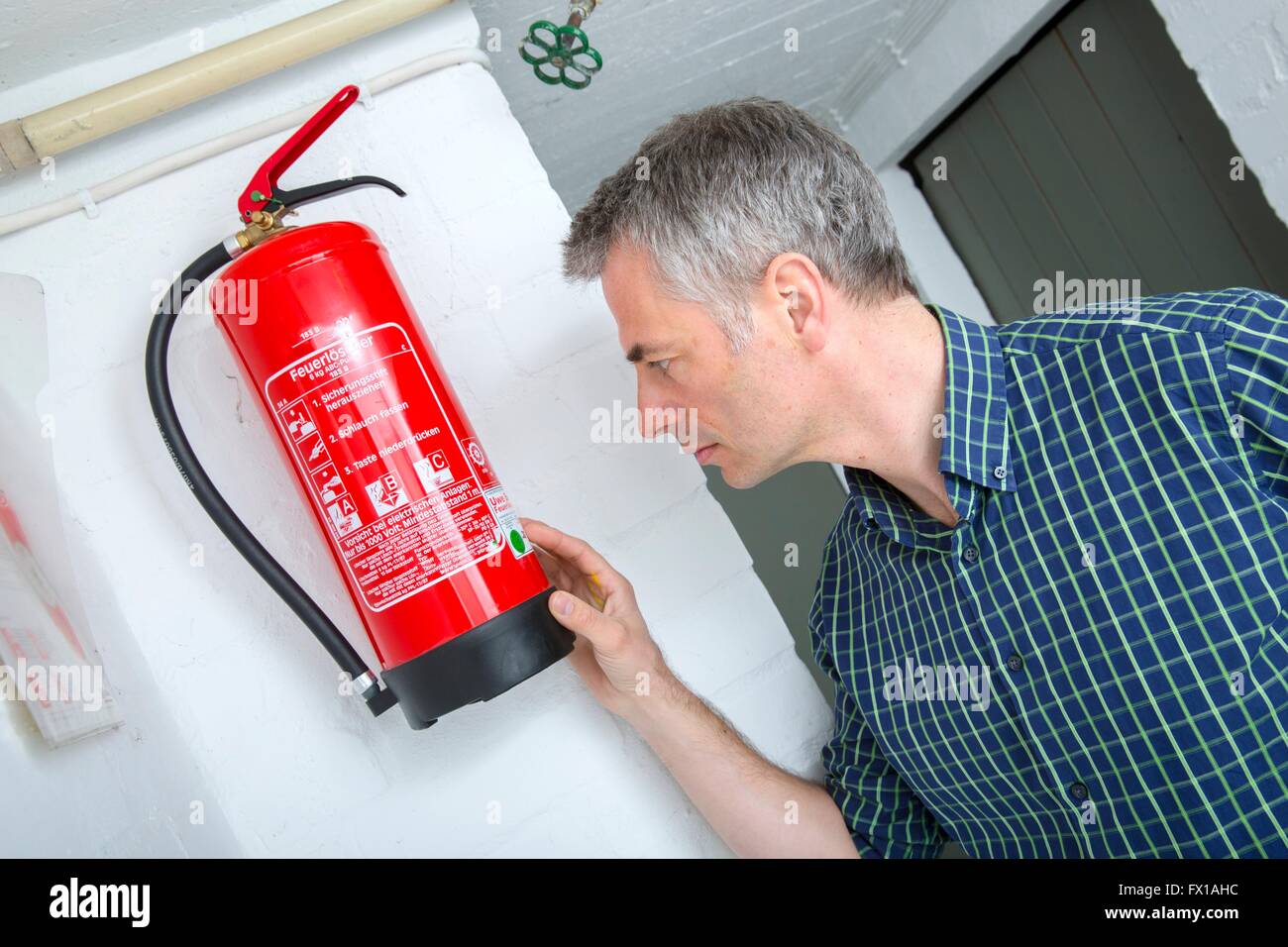 Man with fire extinguisher hi-res stock photography and images - Alamy