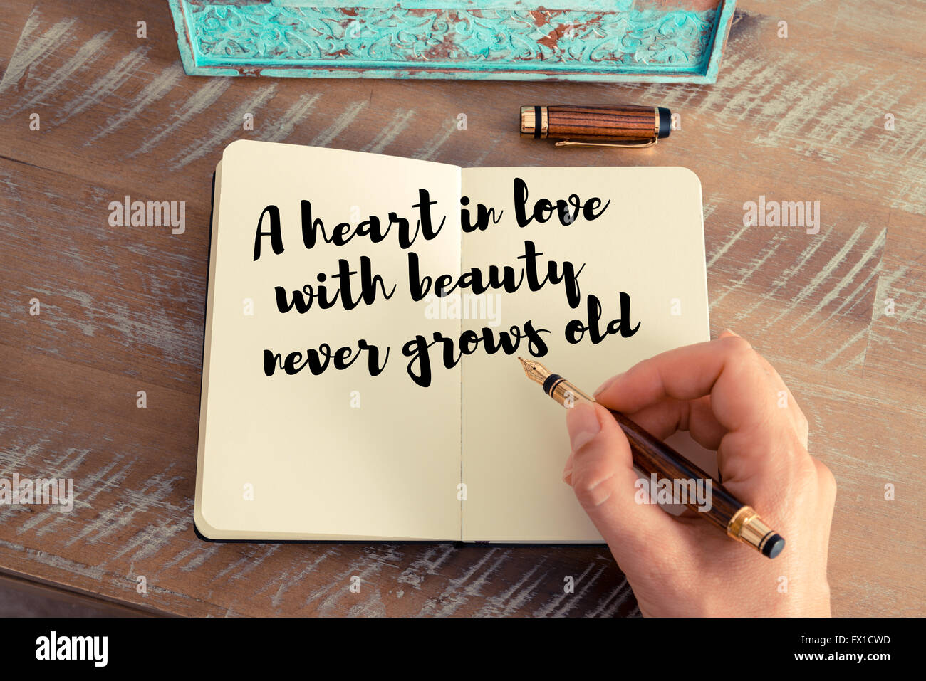Retro effect and toned image of a woman hand writing on a notebook ...