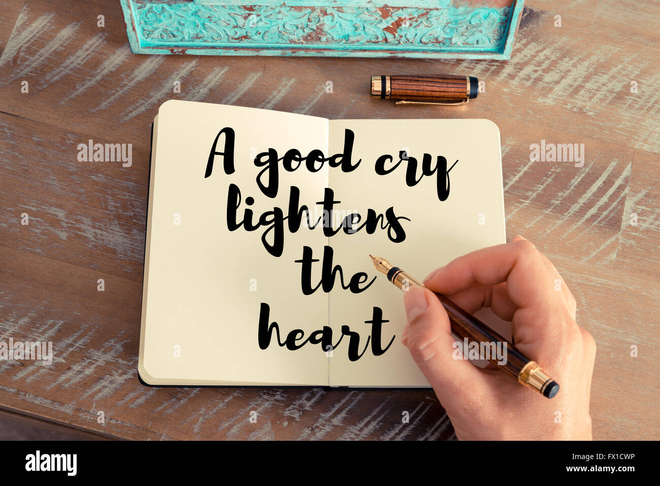 Retro effect and toned image of a woman hand writing on a notebook ...