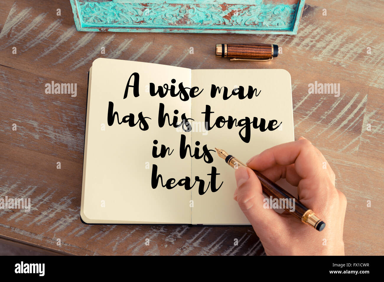 Retro effect and toned image of a woman hand writing on a notebook ...