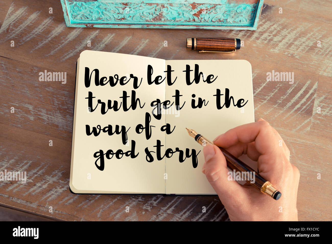 Retro effect and toned image of a woman hand writing on a notebook ...
