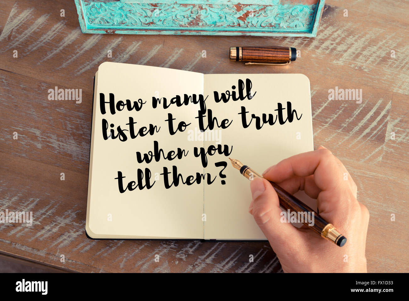 Retro effect and toned image of a woman hand writing on a notebook ...