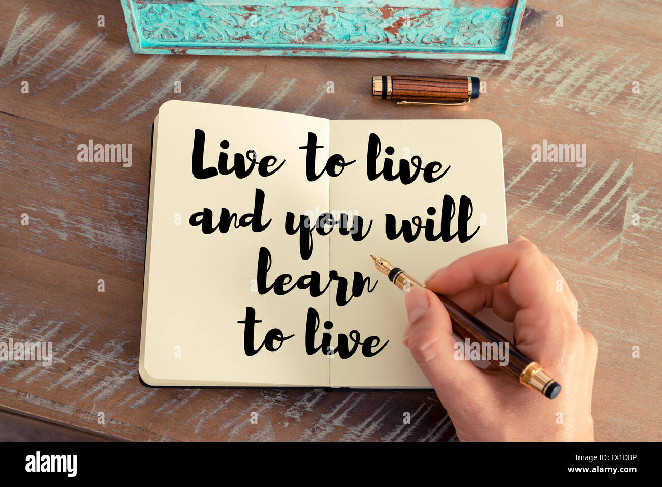 Retro effect and toned image of a woman hand writing on a notebook ...
