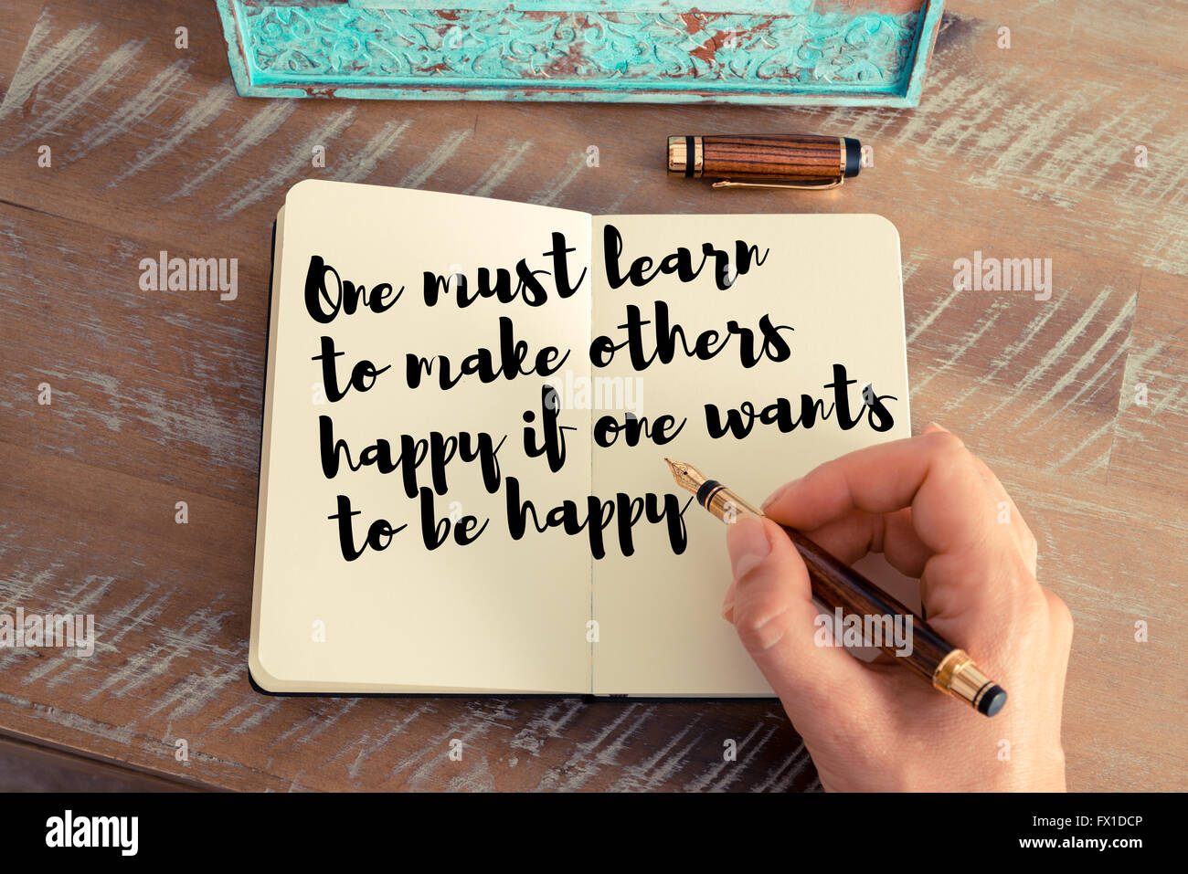 Retro effect and toned image of a woman hand writing on a notebook ...