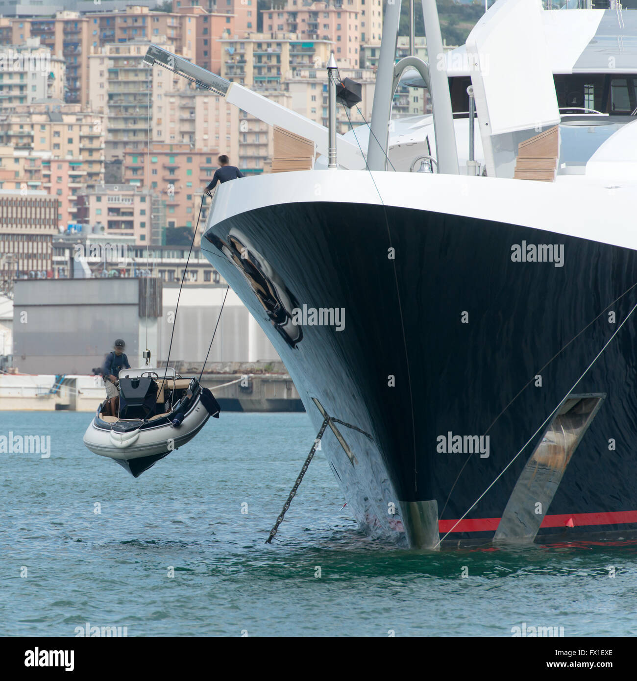 small boat lowered by a large yacht Stock Photo - Alamy