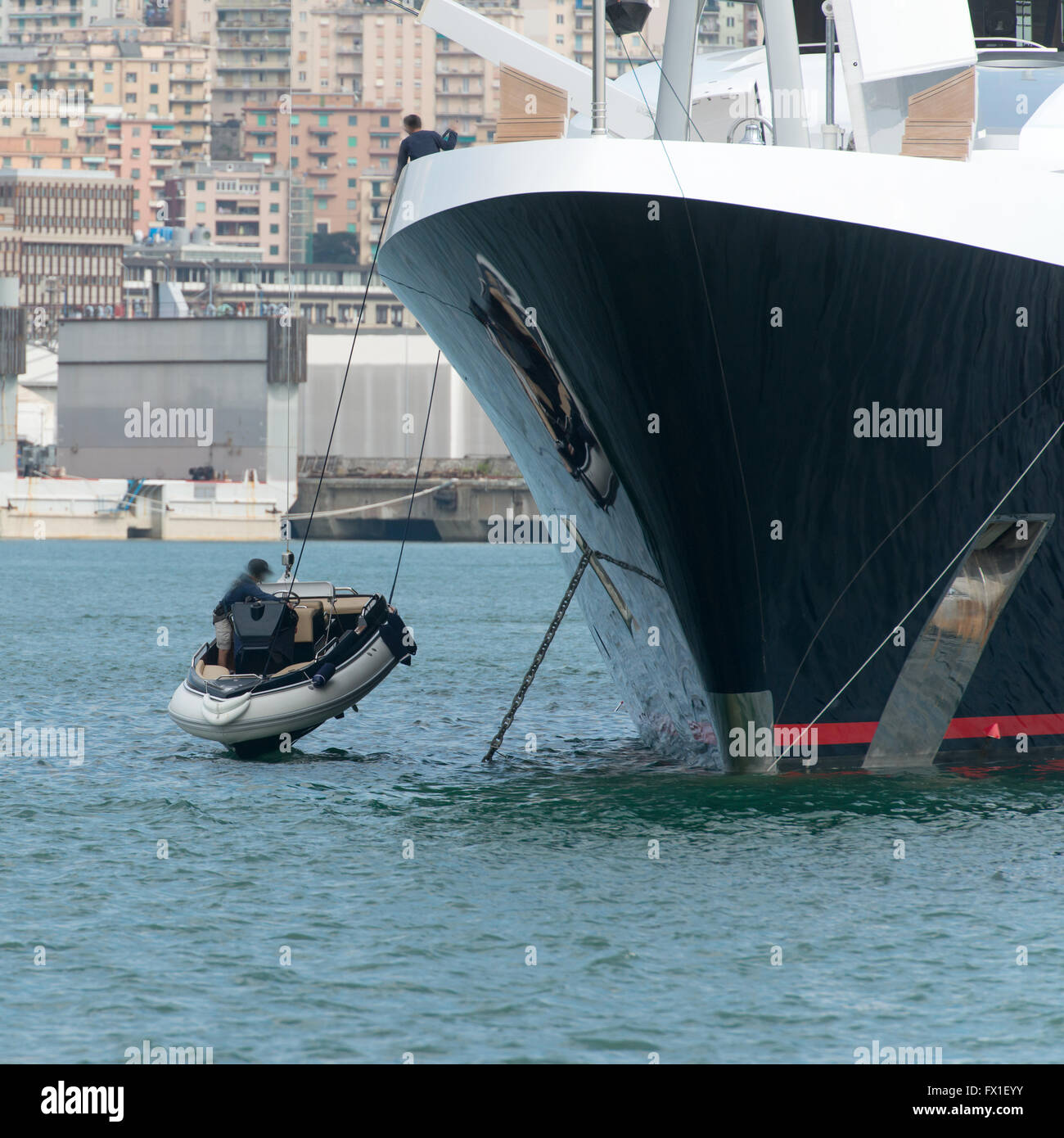 small boat lowered by a large yacht Stock Photo - Alamy