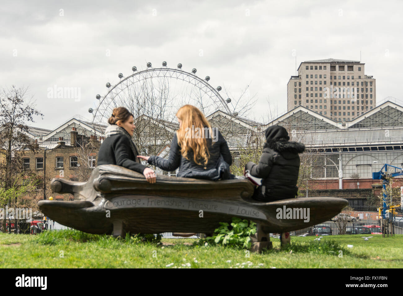 Three women having a chat on a park bench in Waterloo Millennium Green ...