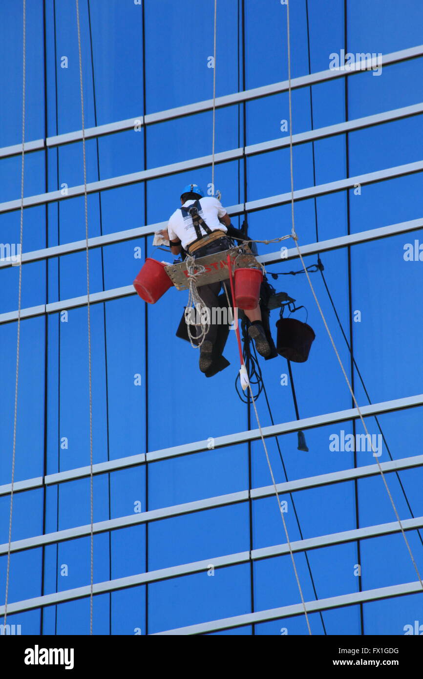 window cleaner hanging on rope at work on skyscraper Stock Photo - Alamy