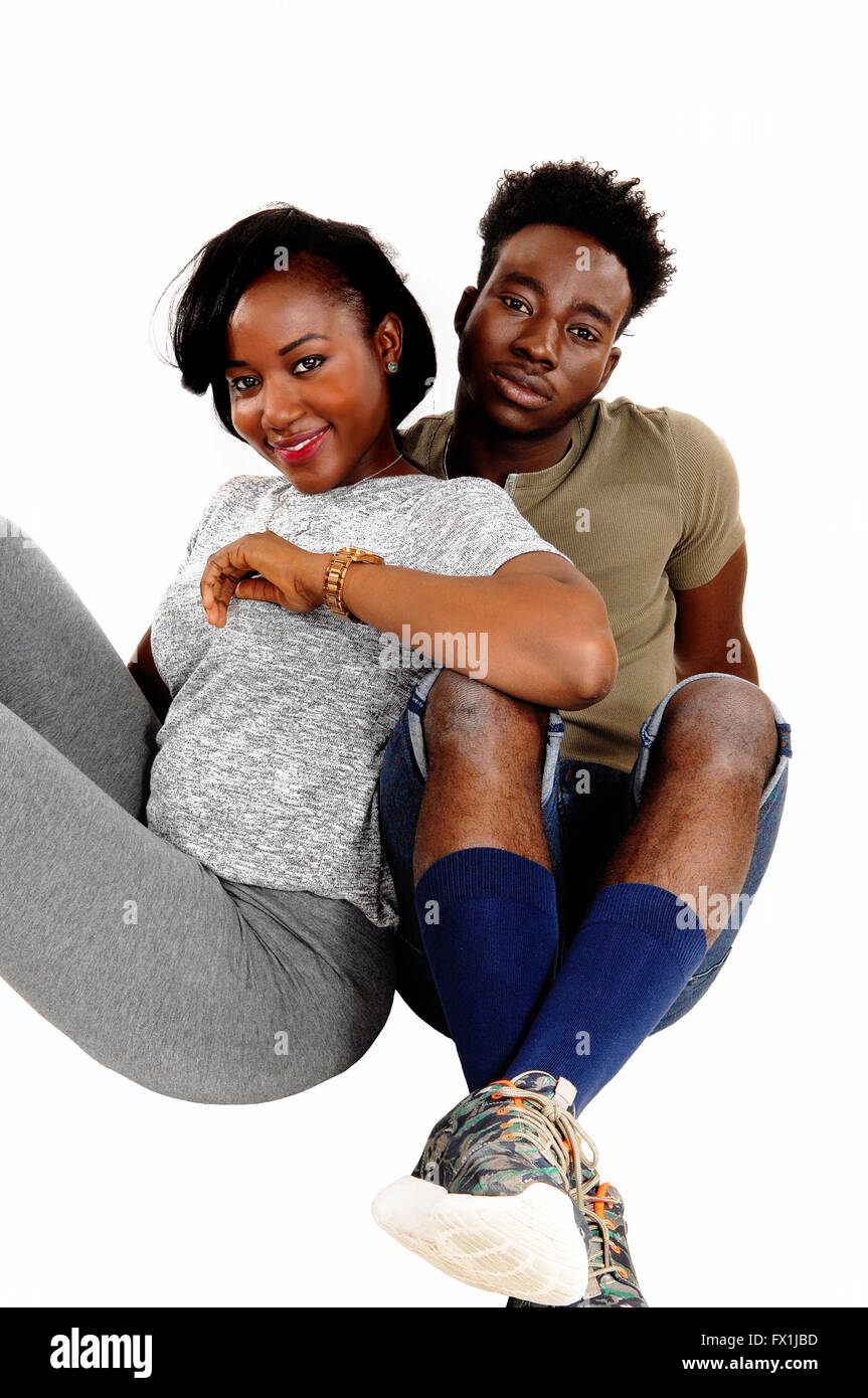 A young pretty African American couple sitting on the floor in the ...