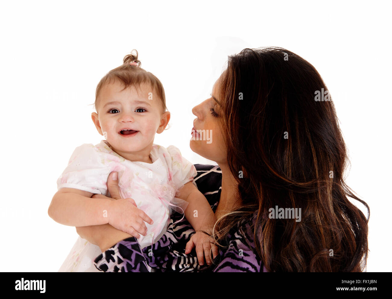 A lovely baby looking over the shoulder from her mom, isolated for ...