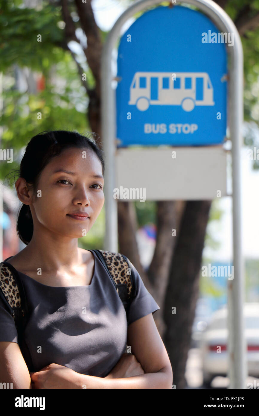 woman standing at a bus stop Stock Photo - Alamy
