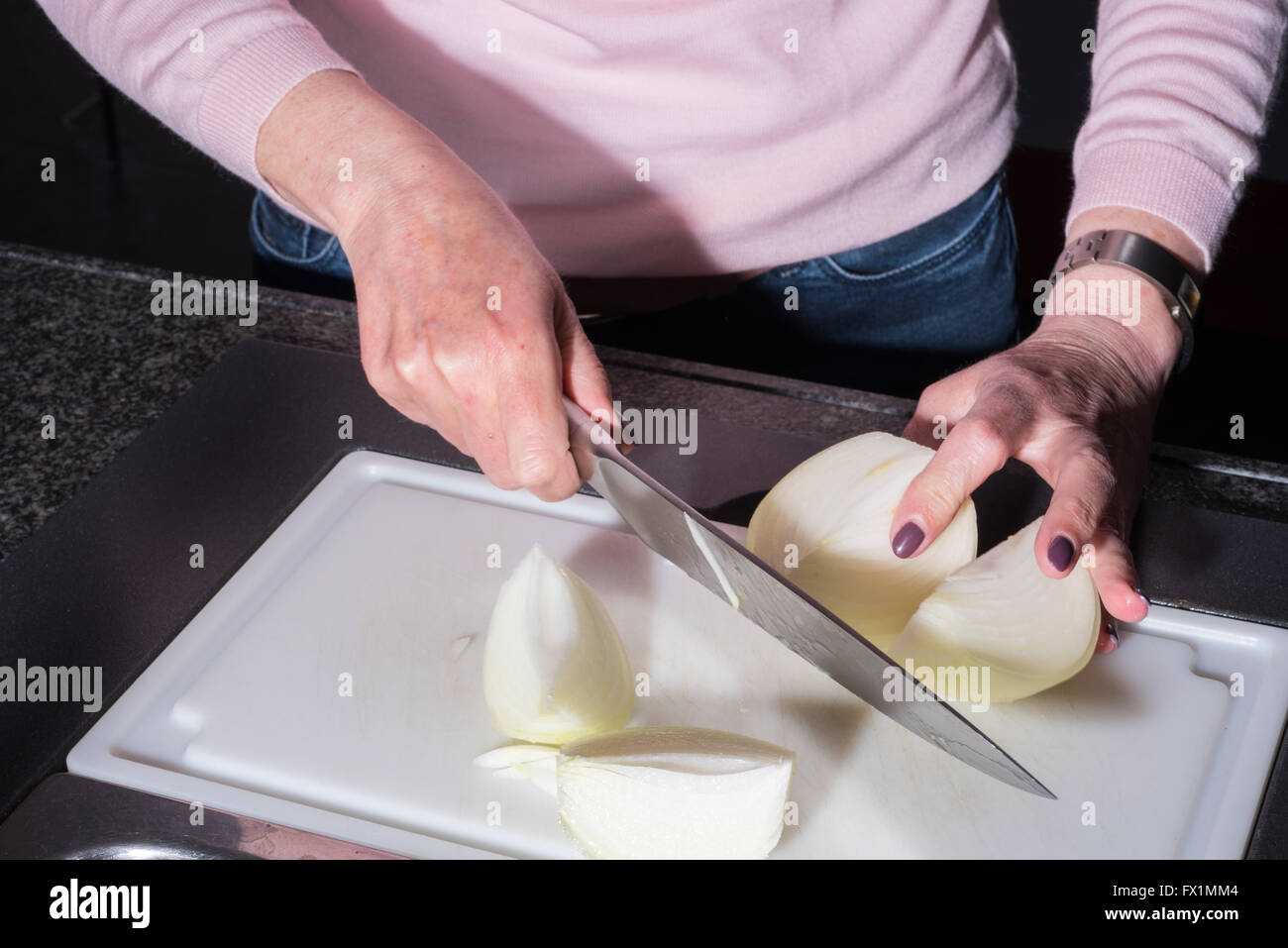 woman is cutting big onions in the kitchen Stock Photo - Alamy