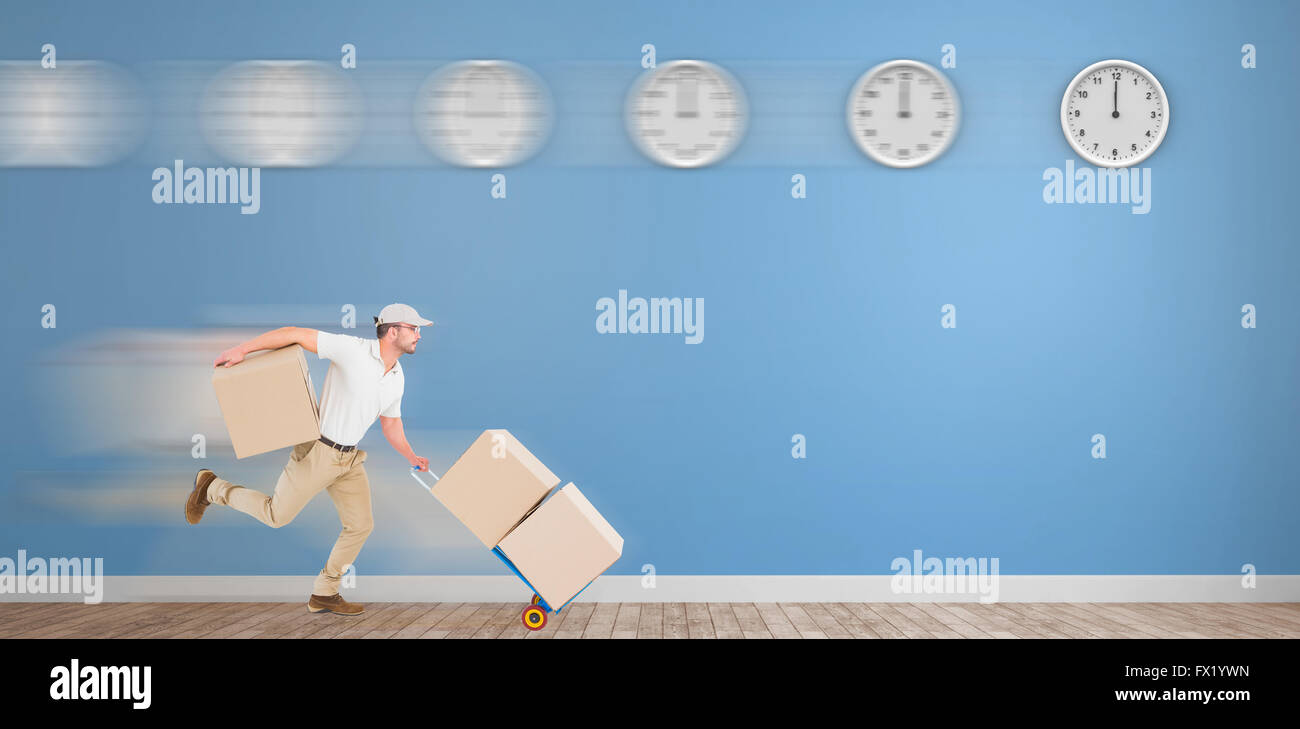 Delivery man with trolley of boxes running Stock Photo - Alamy
