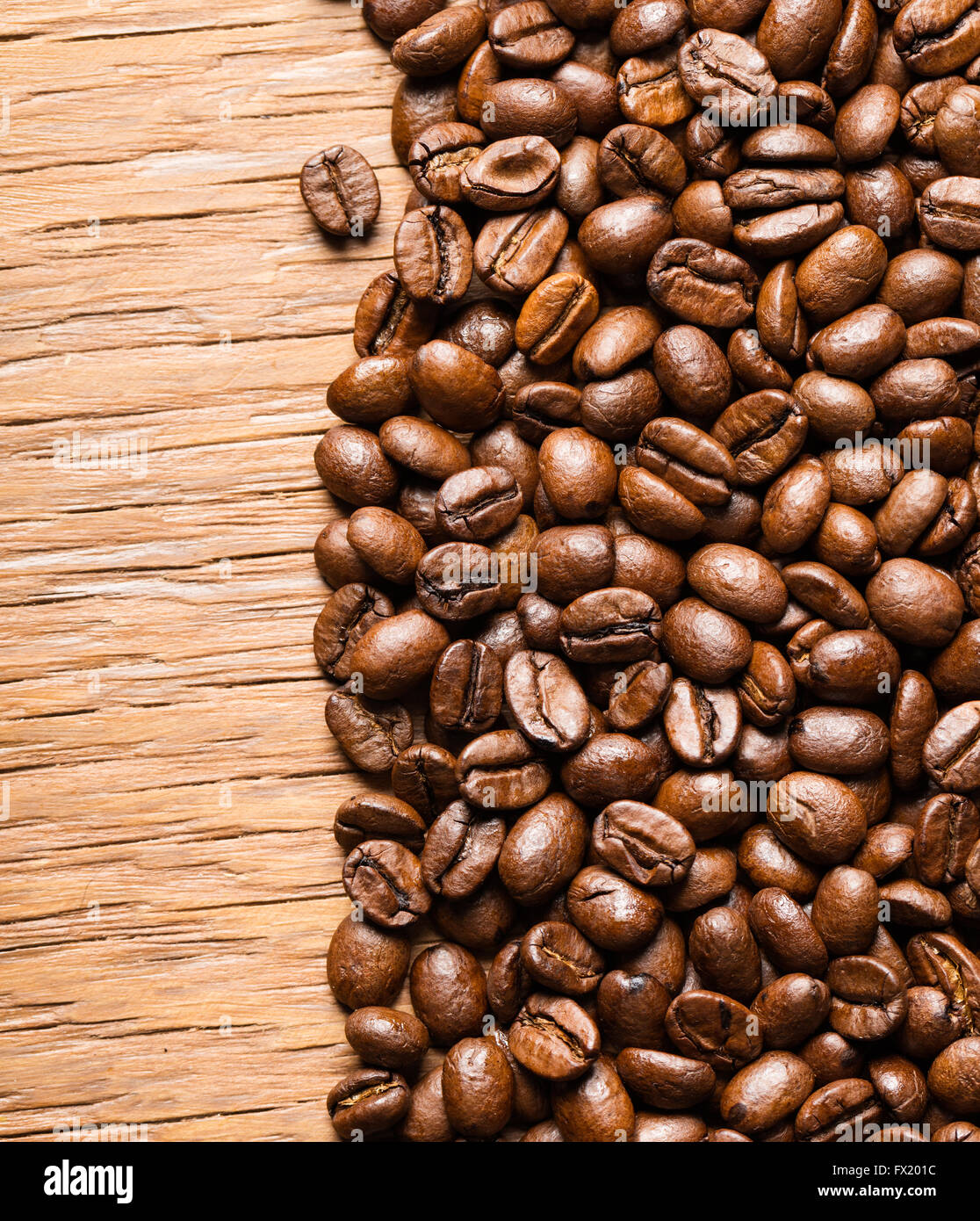 fragrant fried coffee beans on a wooden background Stock Photo - Alamy