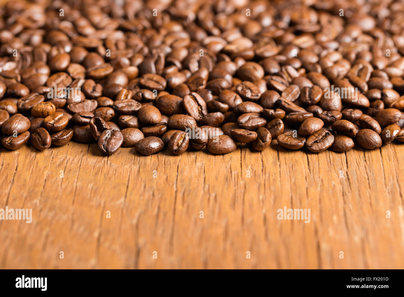 fragrant fried coffee beans on a wooden background Stock Photo - Alamy