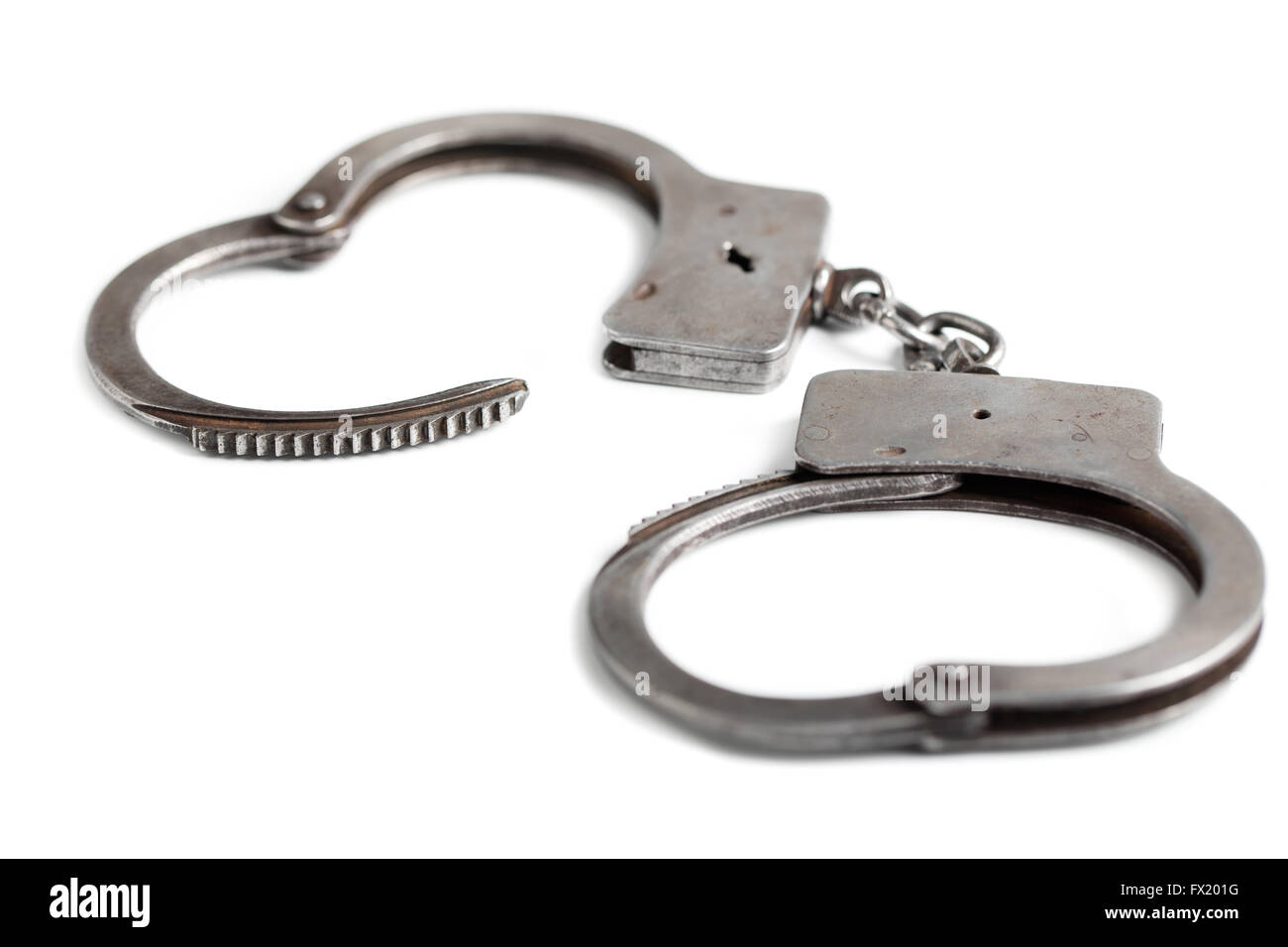 metal handcuffs closeup isolated on a white background Stock Photo - Alamy