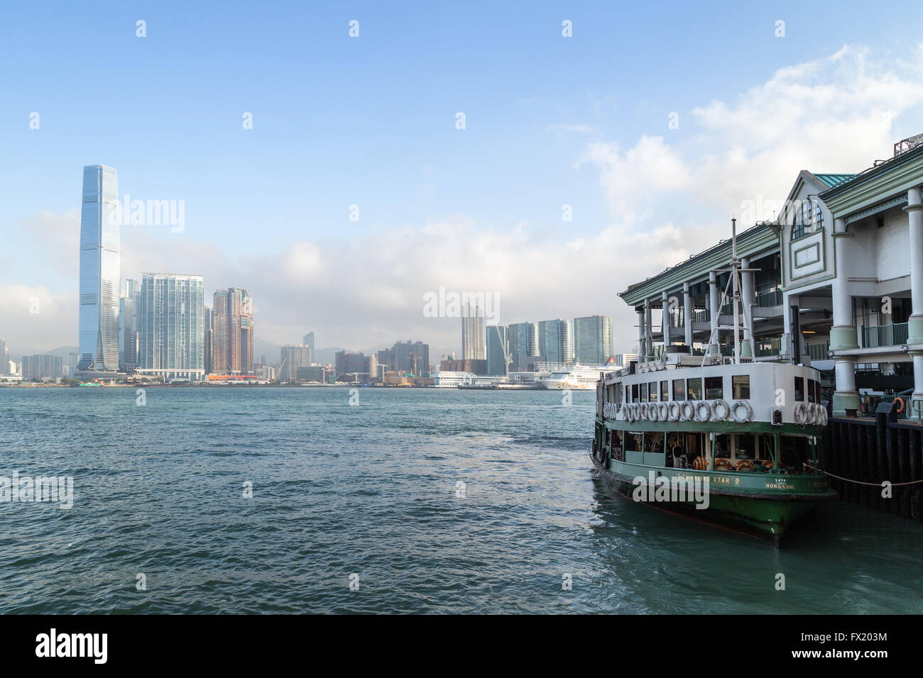 Star Ferry at a pier in Central, Hong Kong, China. Skyscrapers in ...