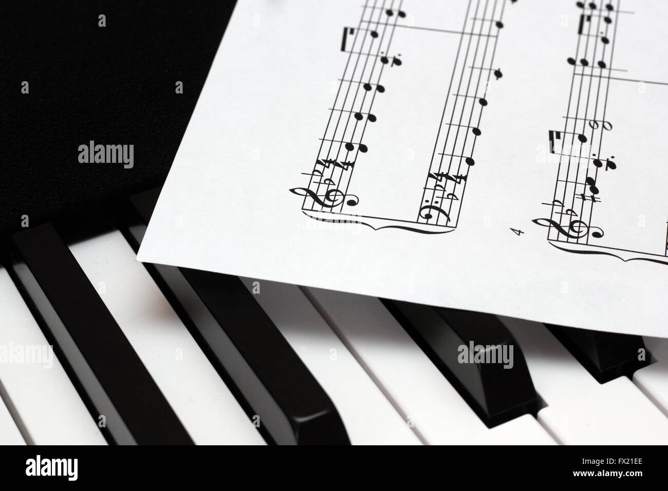 Music paper sheet lying on th piano keys photo Stock Photo - Alamy
