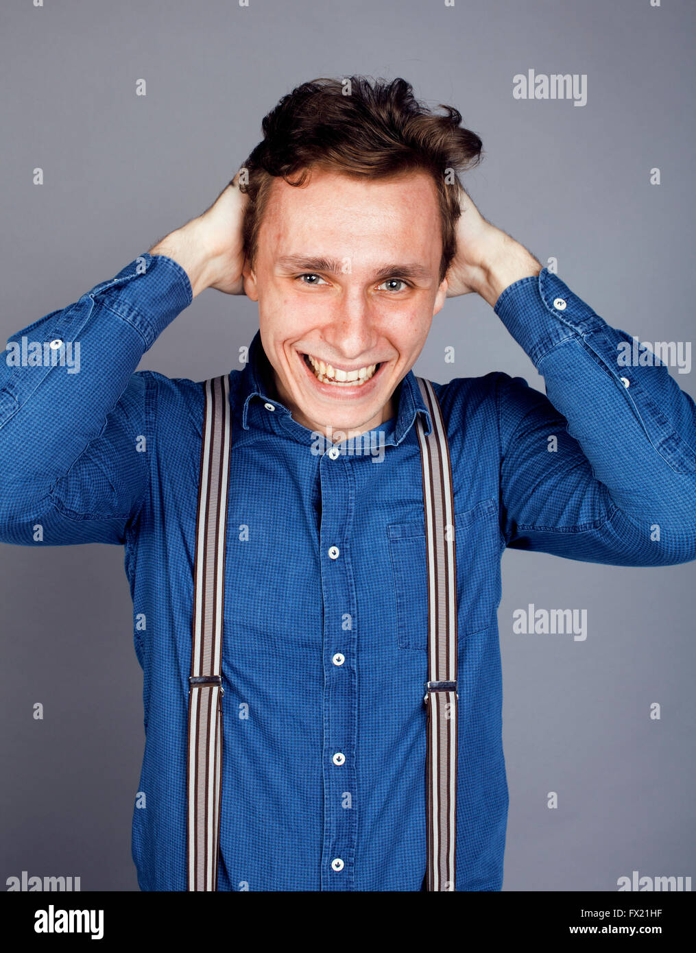 young goofy man with pimples pointing in studio Stock Photo - Alamy
