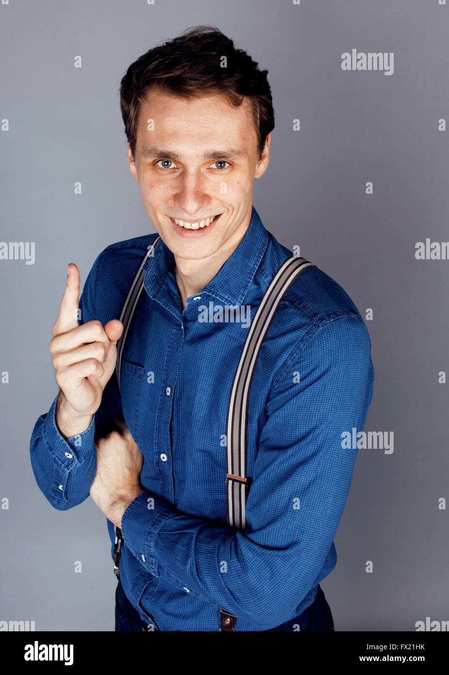 young goofy man with pimples pointing in studio Stock Photo - Alamy