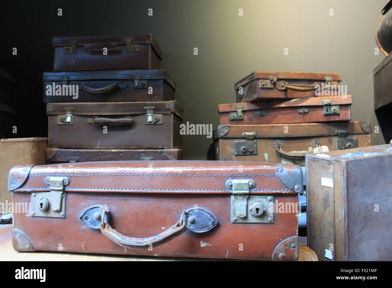 Stacks of very old vintage leather suitcases arranged with the main ...