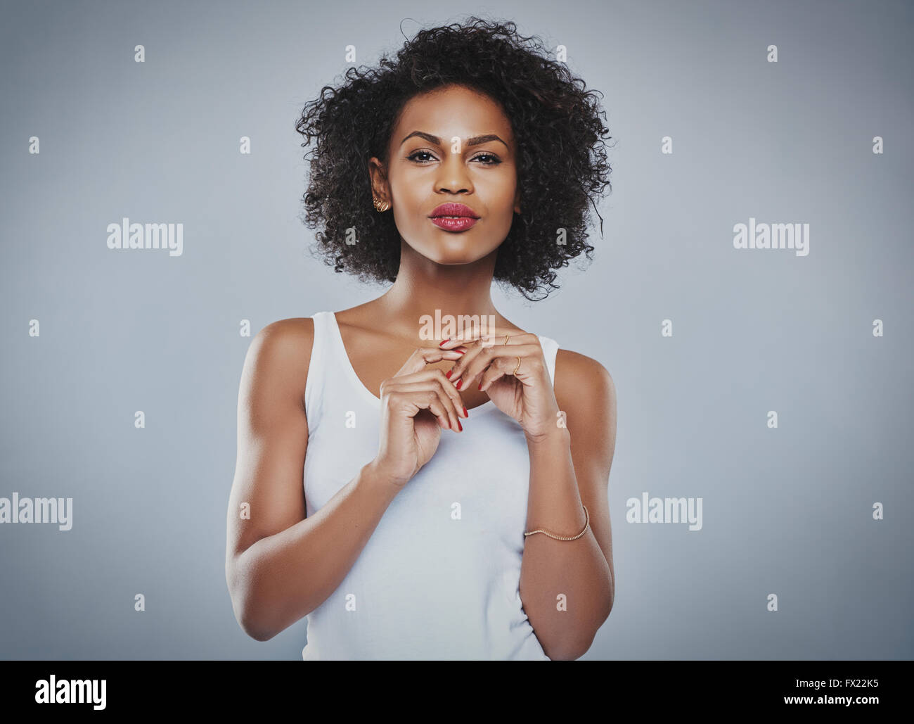 Intense flirting woman looking at camera, black woman with curly hair ...