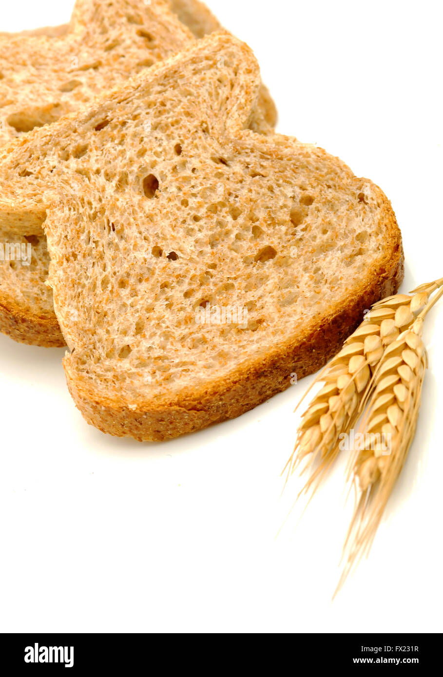 Whole wheat bread slices on white background Stock Photo - Alamy