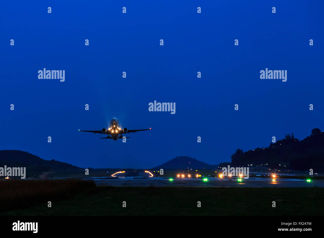 Passenger Airplane take off from runways at night Stock Photo - Alamy