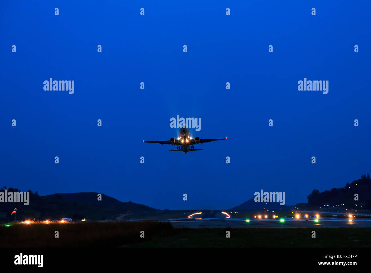 Passenger Airplane take off from runways at night Stock Photo - Alamy