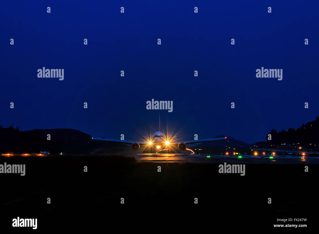 Front view of Passenger Airplane at landing strip in the night Stock ...