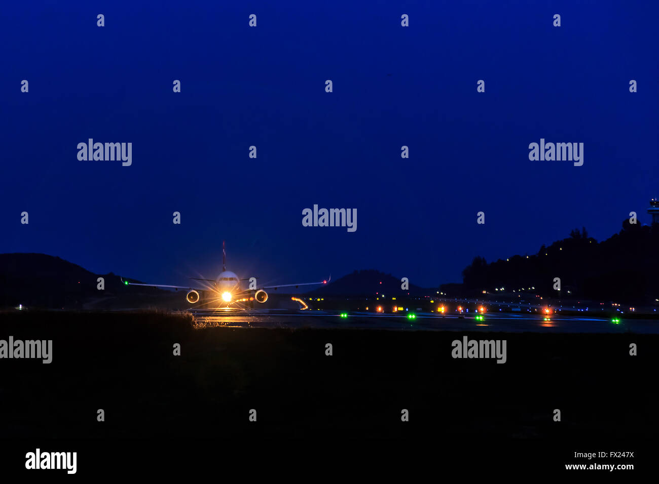Front view of Passenger Airplane at landing strip in the night Stock ...