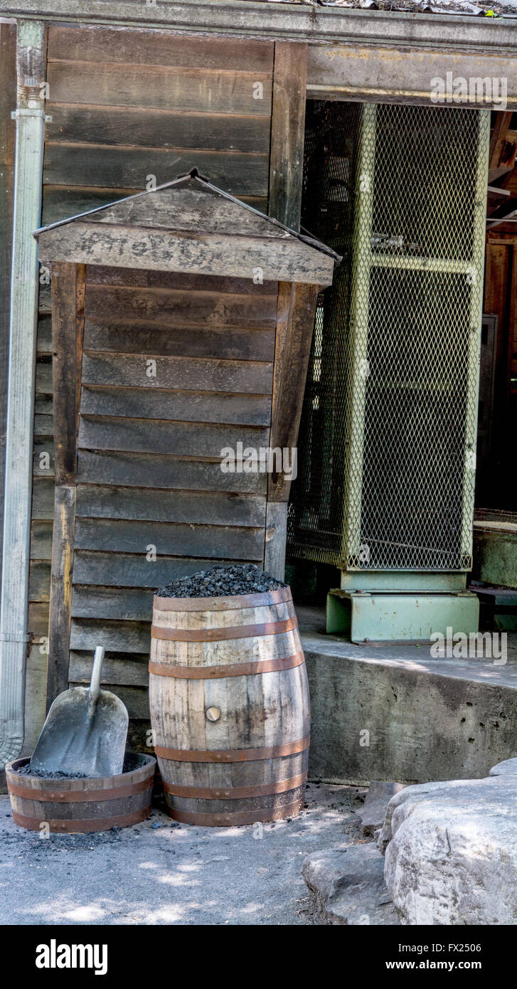 Old building with barrel of coal and shovel Stock Photo - Alamy