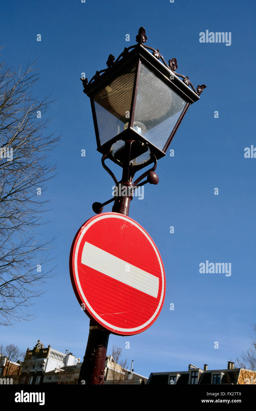 “Stop” traffic sign on old-fashioned street lamp in Amsterdam, The ...
