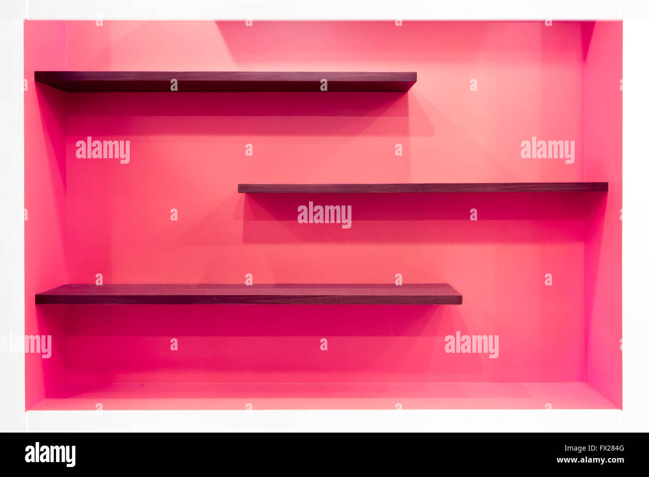 Pink empty modern design shelves on wall Stock Photo - Alamy