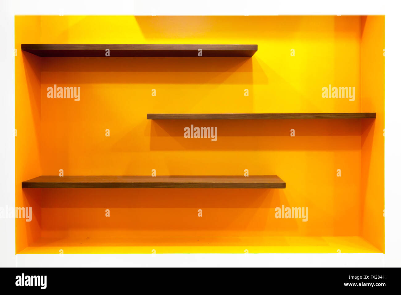 Orange empty modern design shelves on wall Stock Photo - Alamy