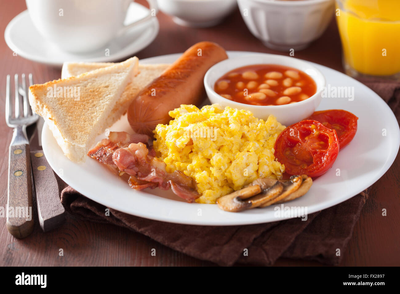 full english breakfast with scrambled eggs, bacon, sausage, beans ...