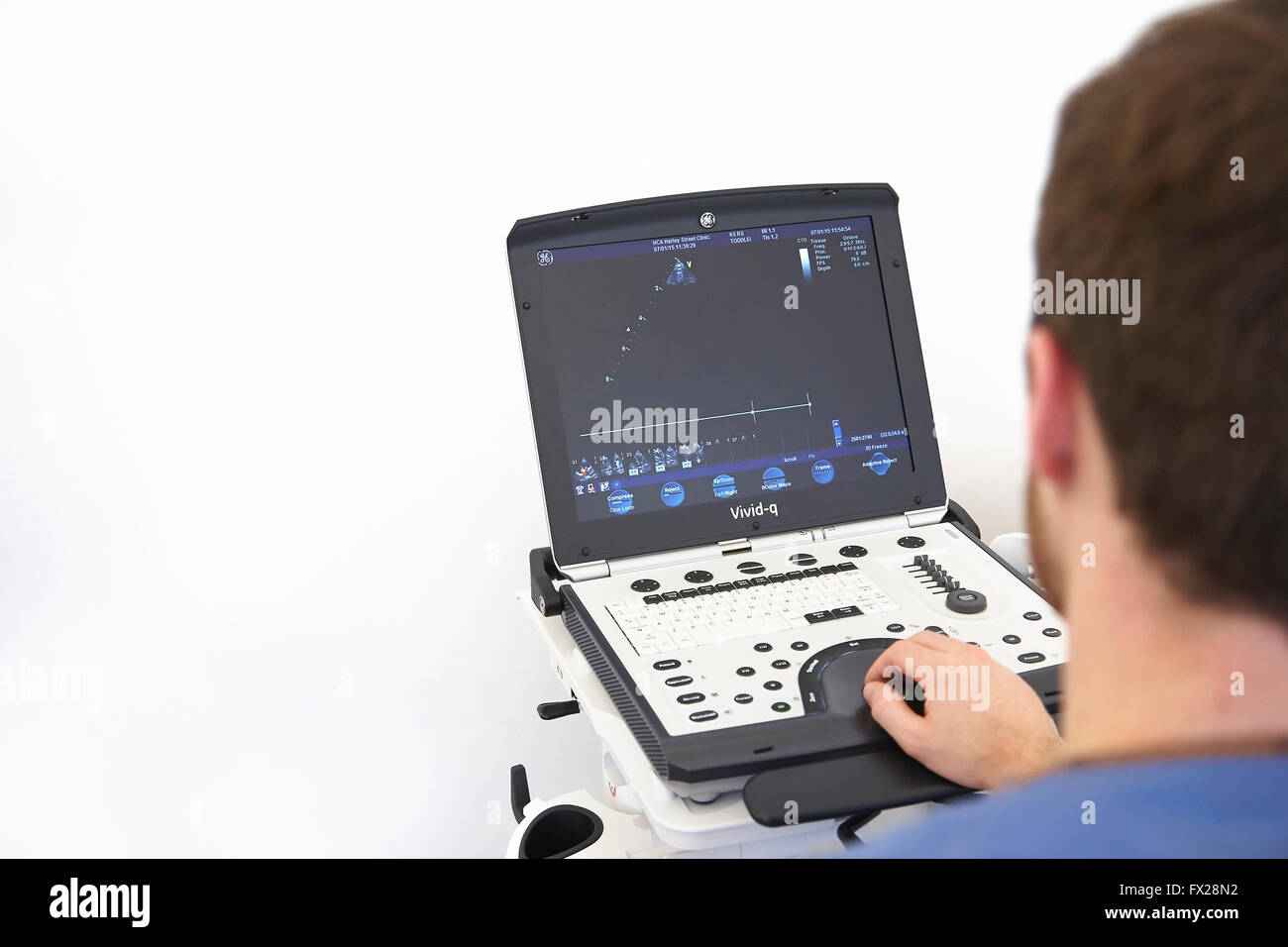 Doctor examining test results on a computer in a hospital in the UK ...