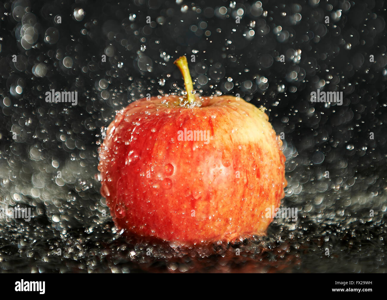Red apple in rain with a dark background Stock Photo - Alamy