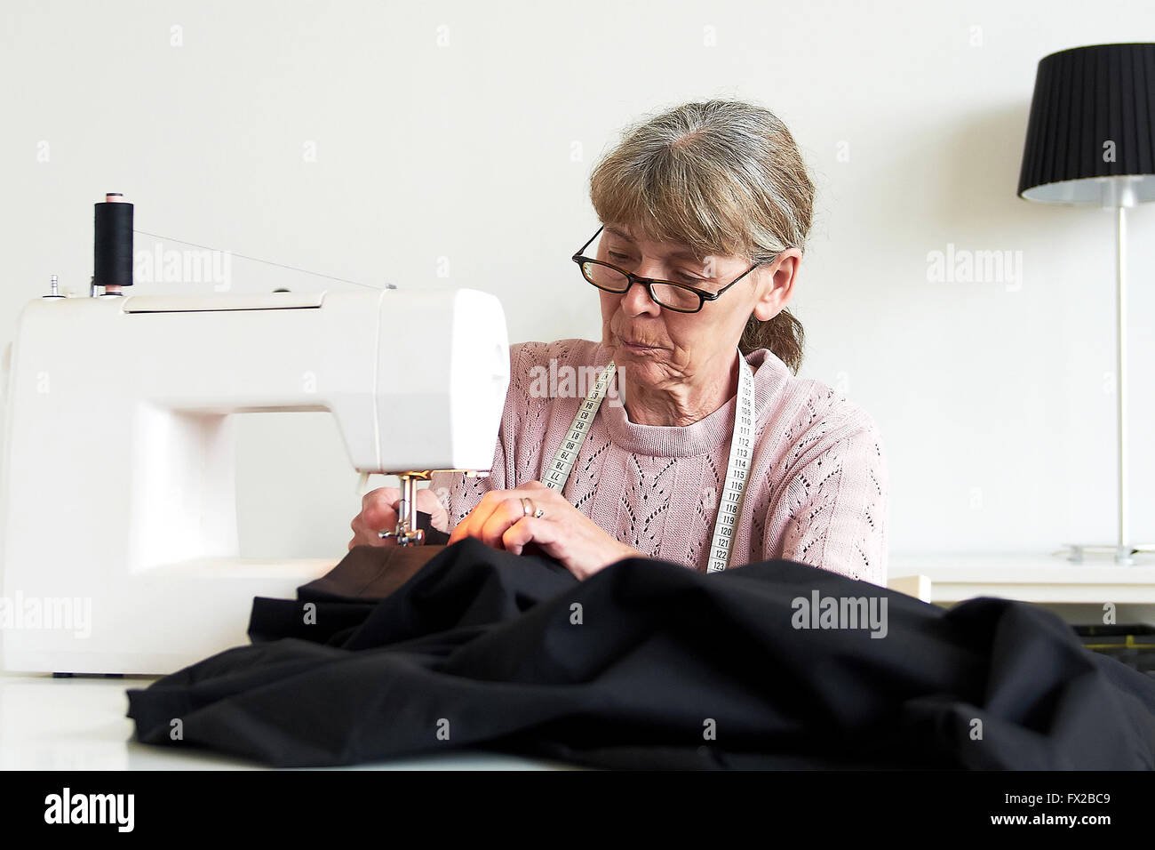 Seamstress working on a sewing machine Stock Photo - Alamy