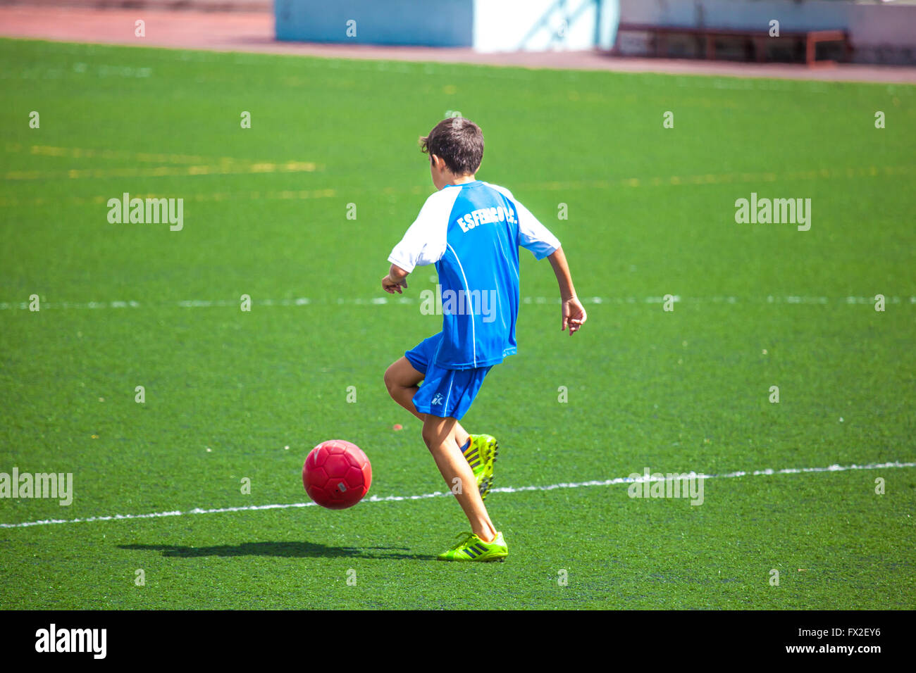 teenager footballer shooting the ball Stock Photo - Alamy