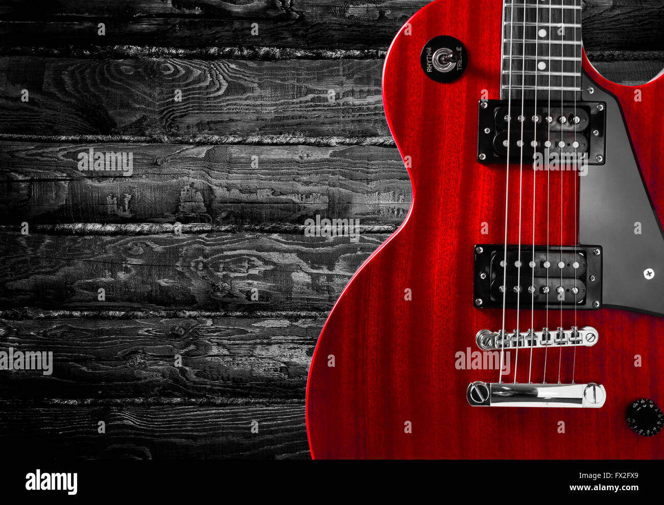Part of the red electric guitar on wooden background. A place for ...