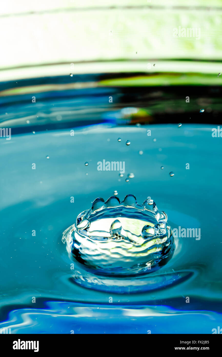 Beautiful colorful water splash from fallen drop Stock Photo - Alamy