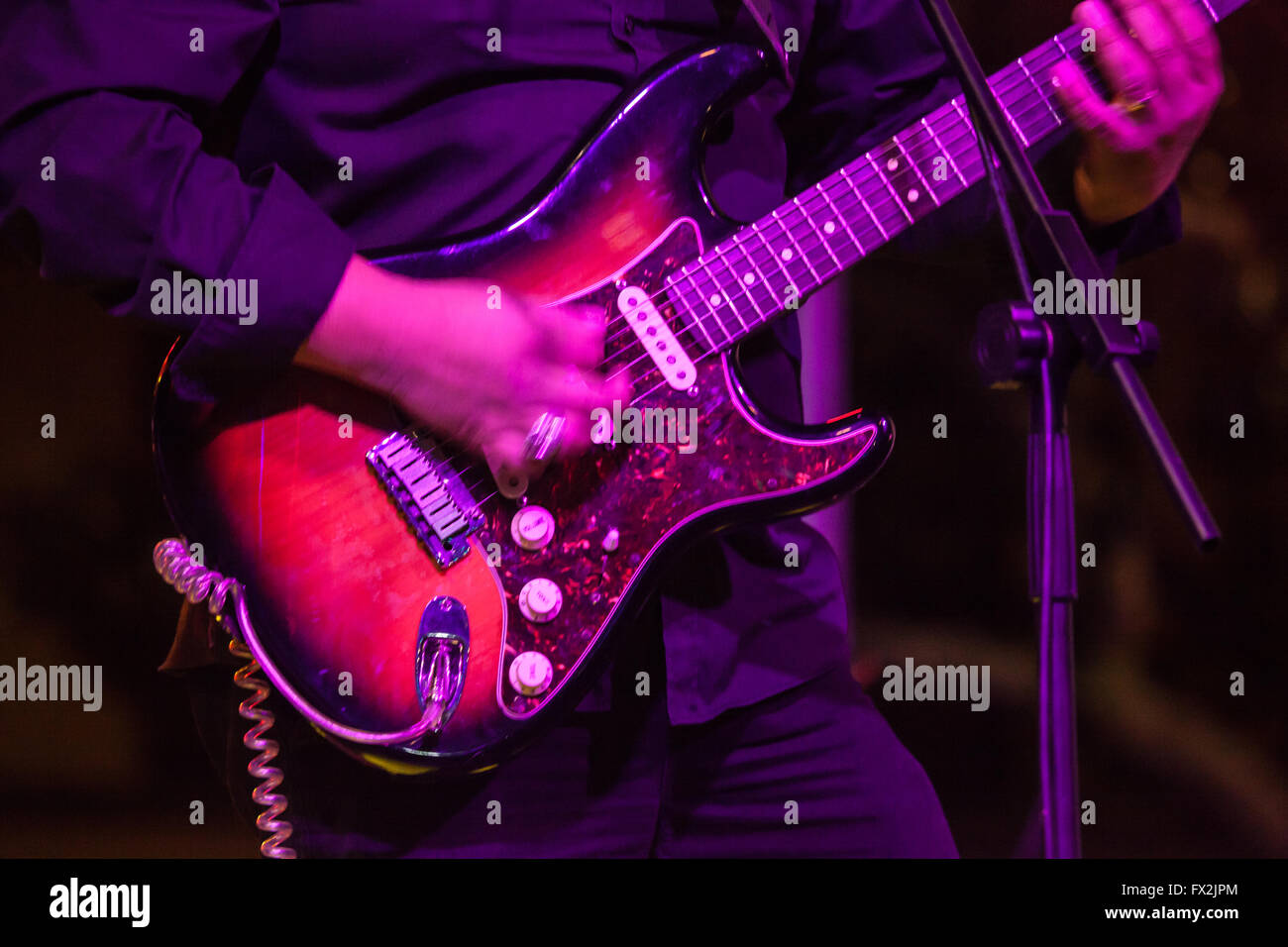 rock musician playing a Fender Stratocaster electric guitar during the ...