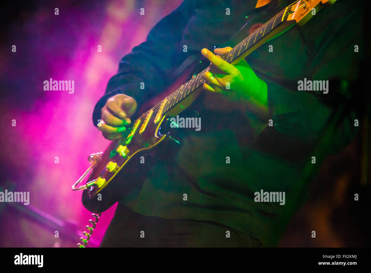 rock musician playing a Fender Stratocaster electric guitar during the ...