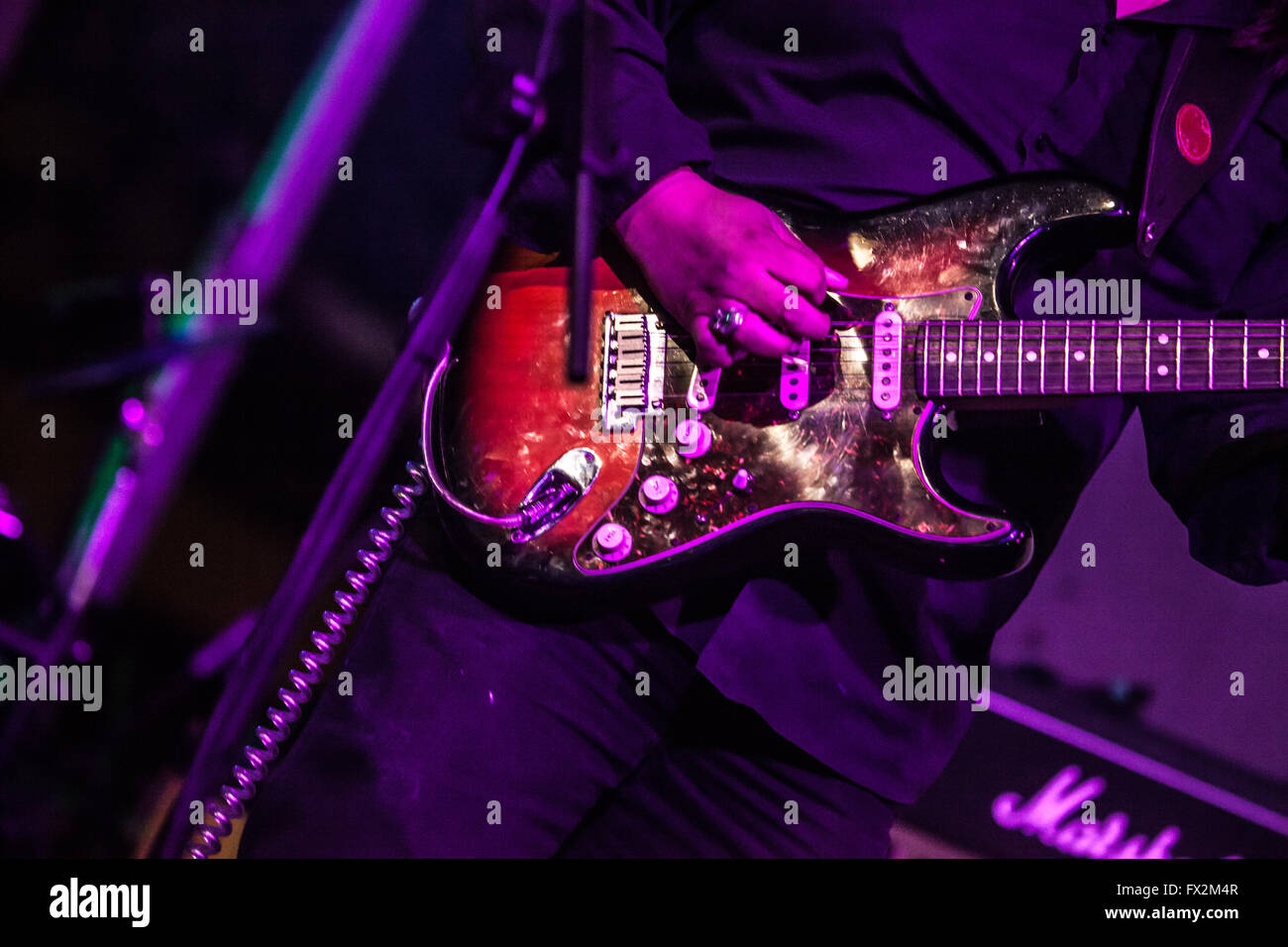 rock musician playing a Fender Stratocaster electric guitar during the ...