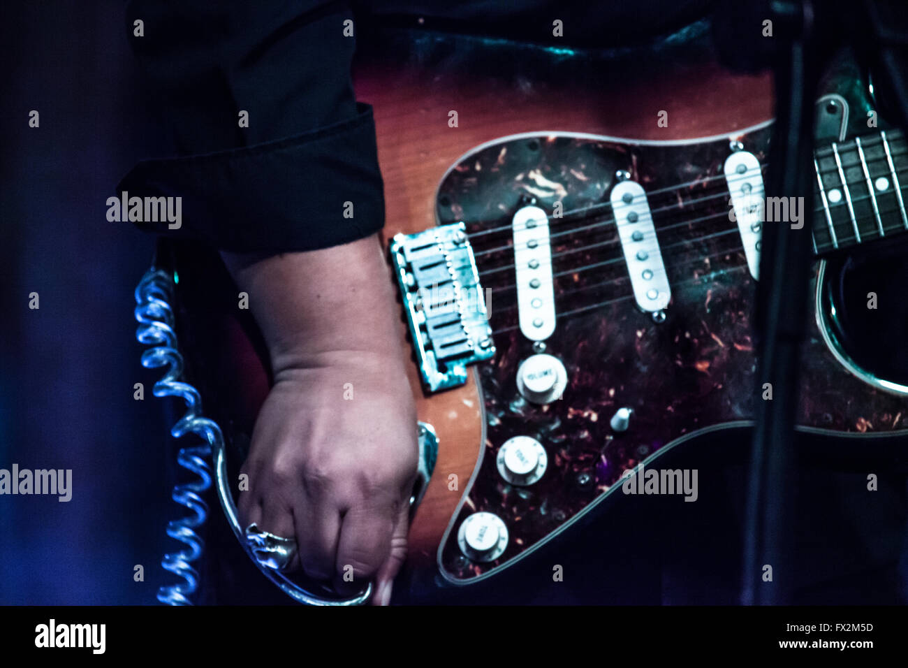 rock musician playing a Fender Stratocaster electric guitar during the ...