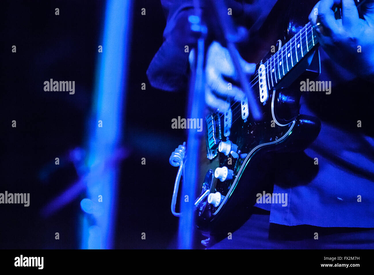 rock musician playing a Fender Stratocaster electric guitar during the ...