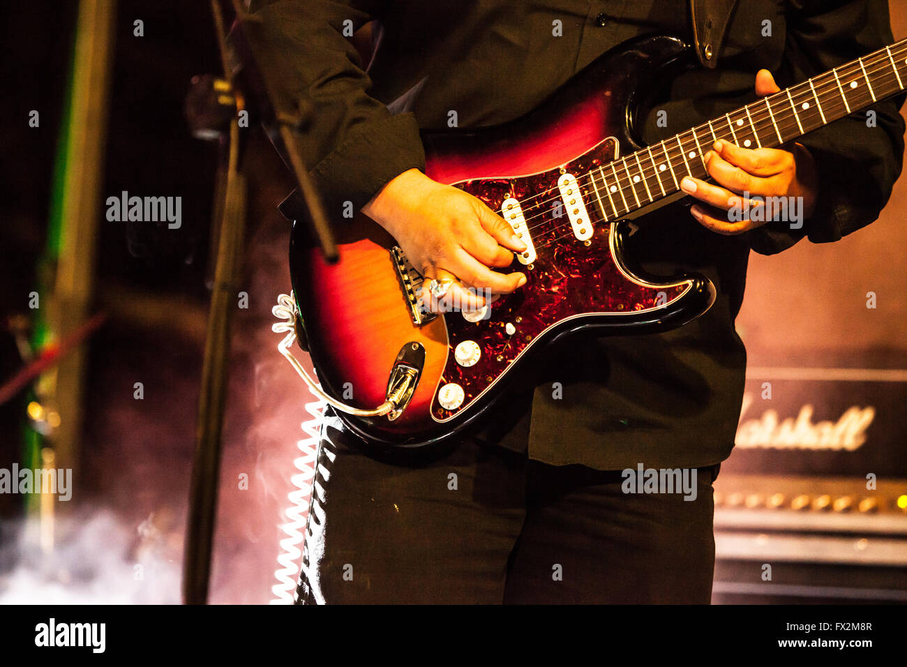 rock musician playing a Fender Stratocaster electric guitar during the ...