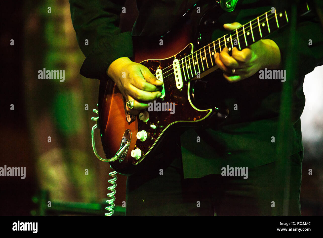 rock musician playing a Fender Stratocaster electric guitar during the ...